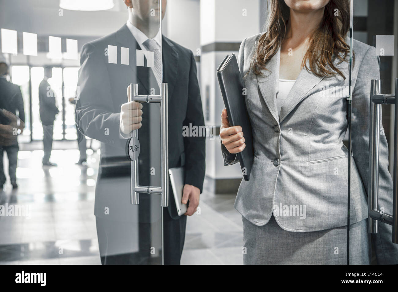 Woman opening door to man hi-res stock photography and images - Alamy