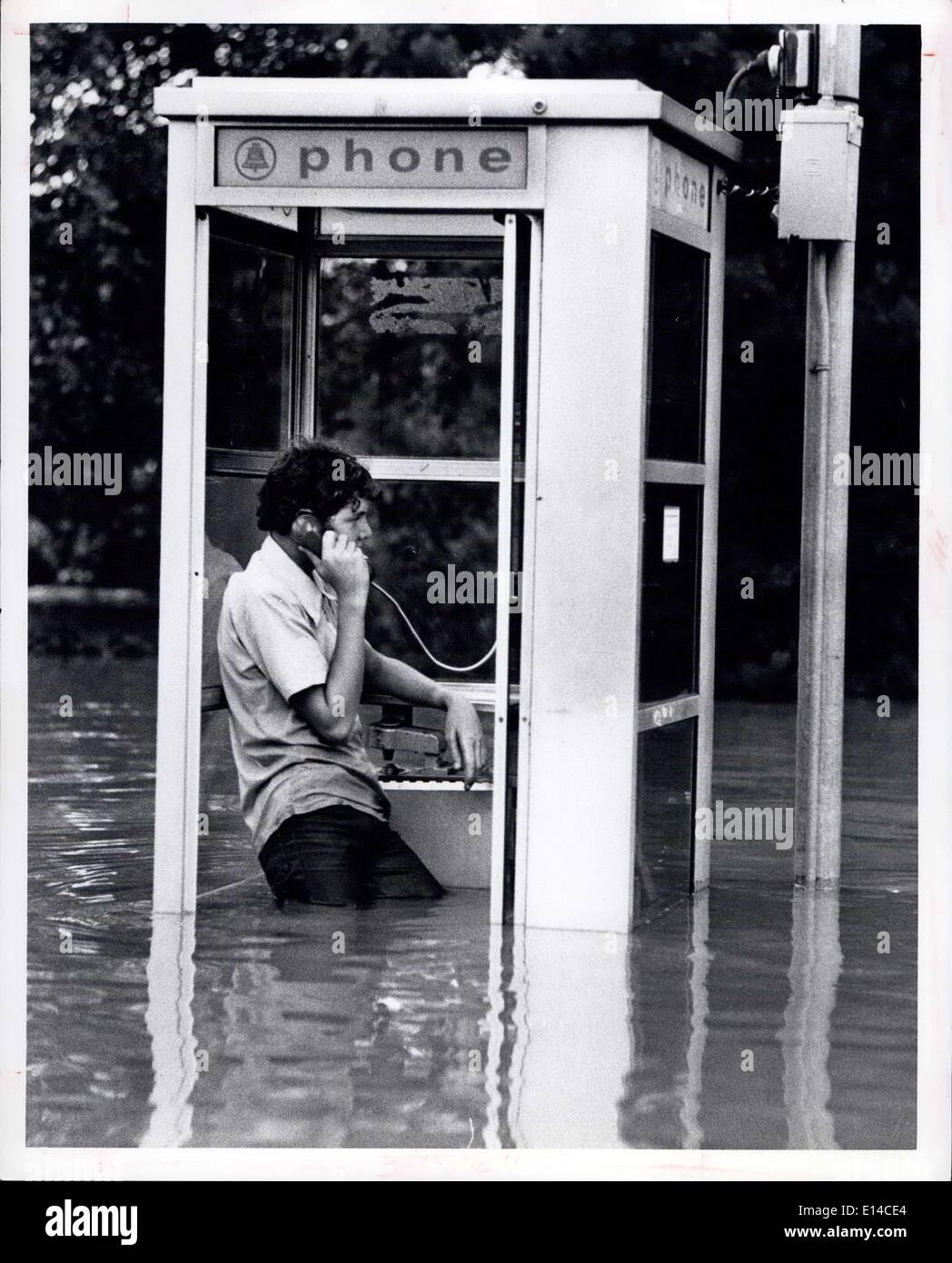 Apr. 17, 2012 - Trenton floods; Police officer making a phone call from ...