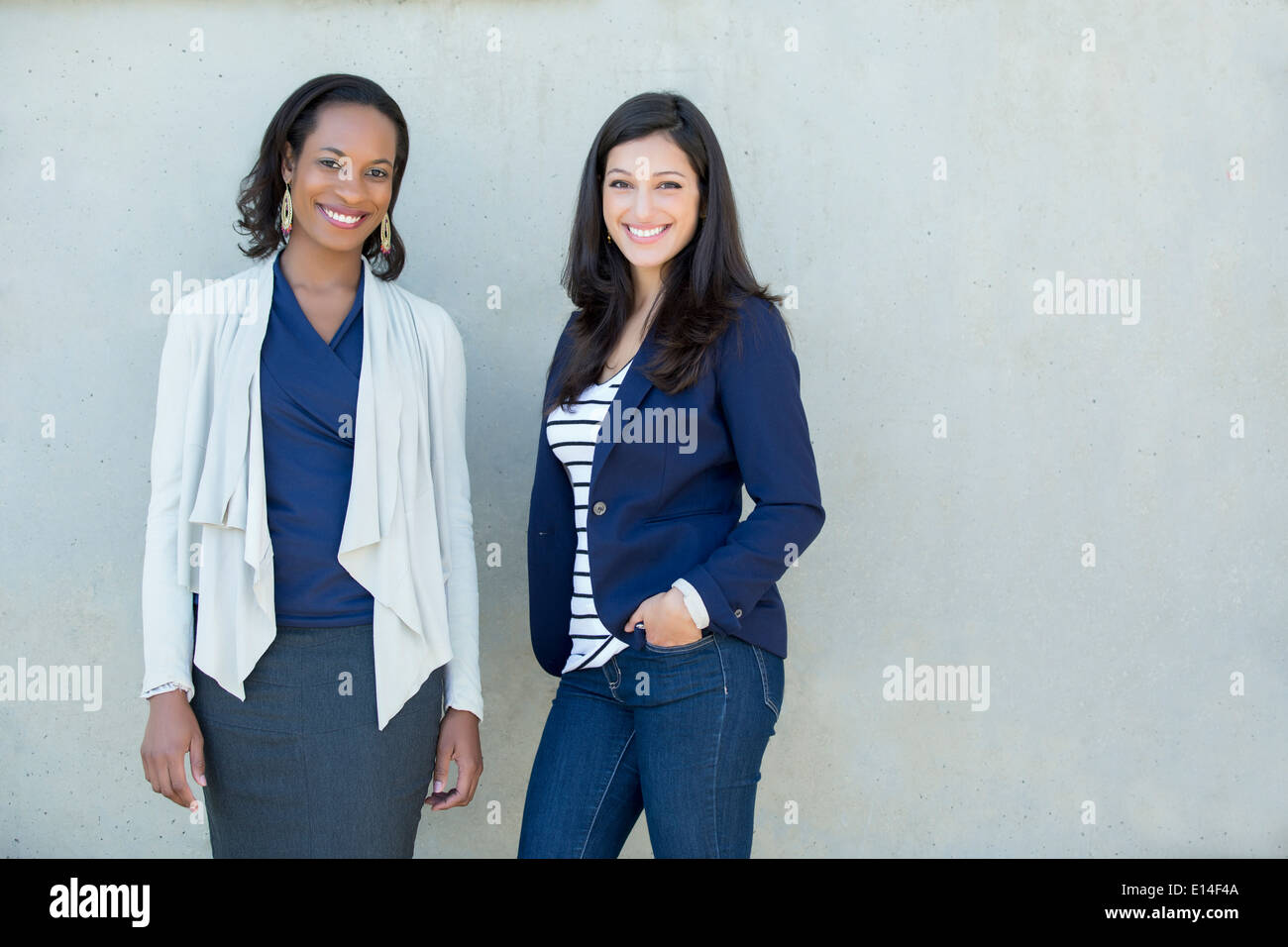 Businesswomen smiling together Stock Photo - Alamy