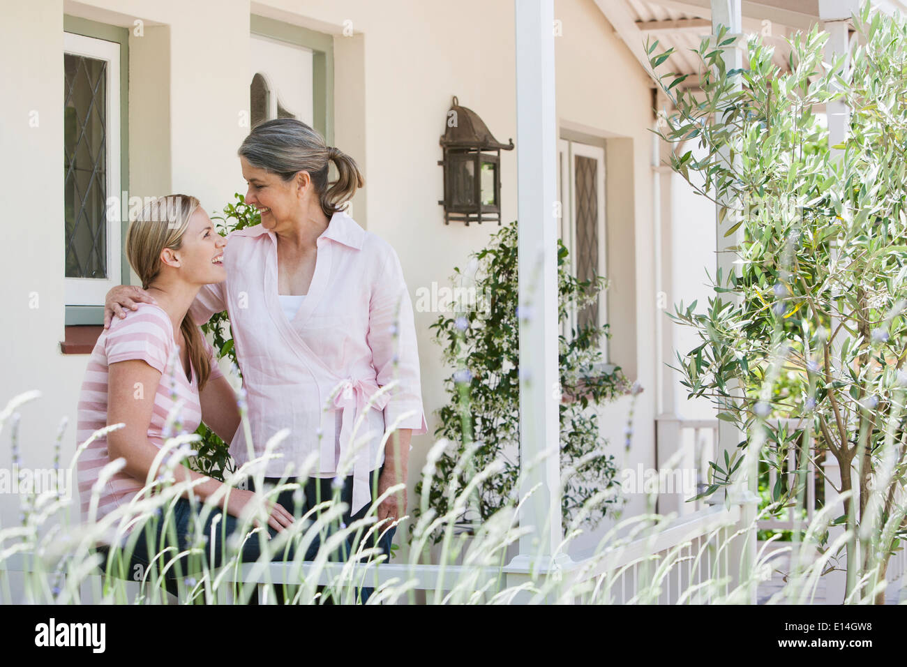 Two women talking on porch hi-res stock photography and images - Alamy