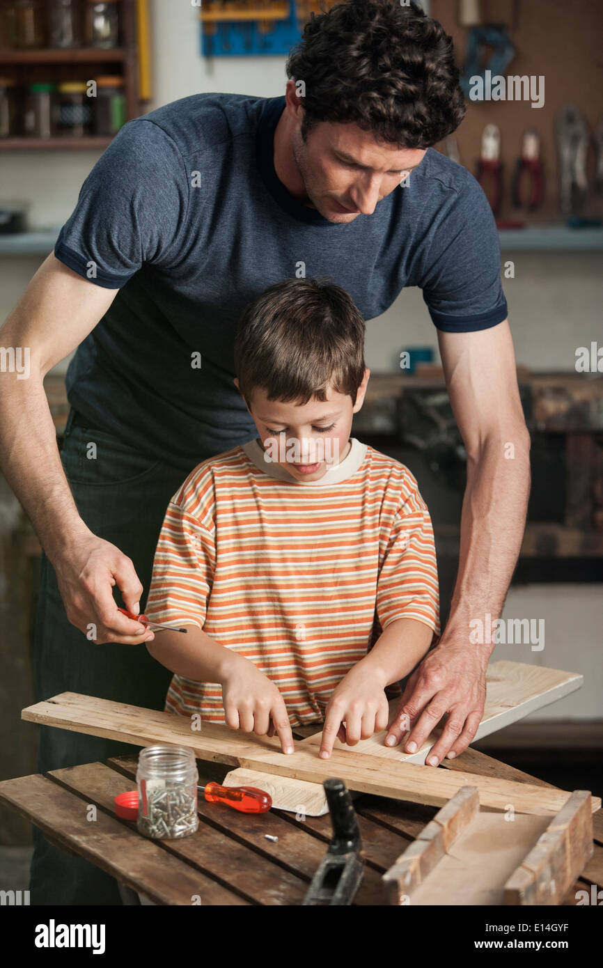 Caucasian father and son working in woodshop Stock Photo - Alamy