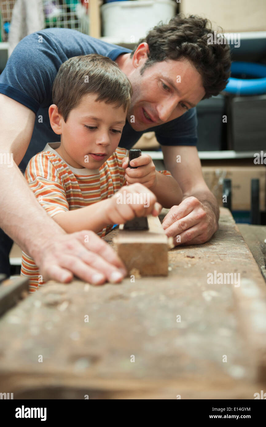 Caucasian father and son working in woodshop Stock Photo - Alamy