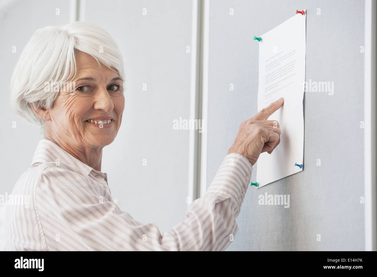 Senior Caucasian woman reading sign Stock Photo - Alamy