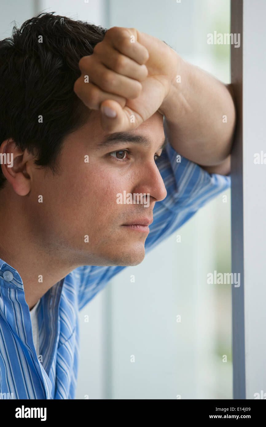 Man looking out window Stock Photo - Alamy