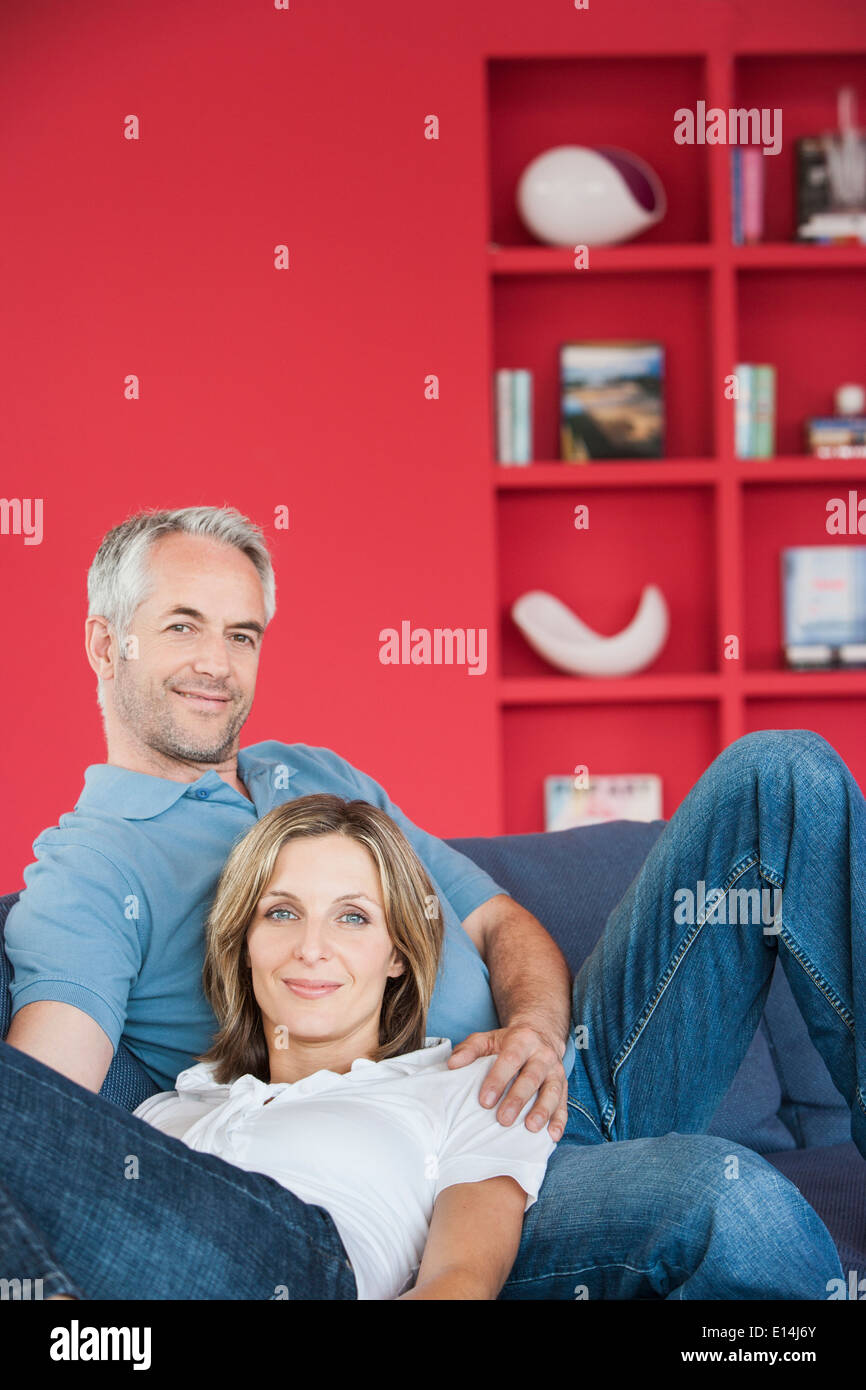 Couple relaxing together in living room Stock Photo - Alamy