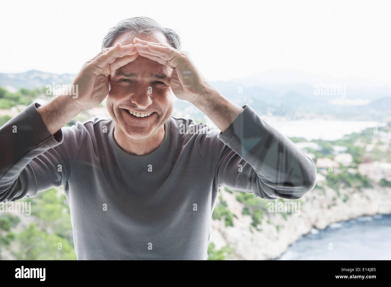Man peering through window Stock Photo - Alamy
