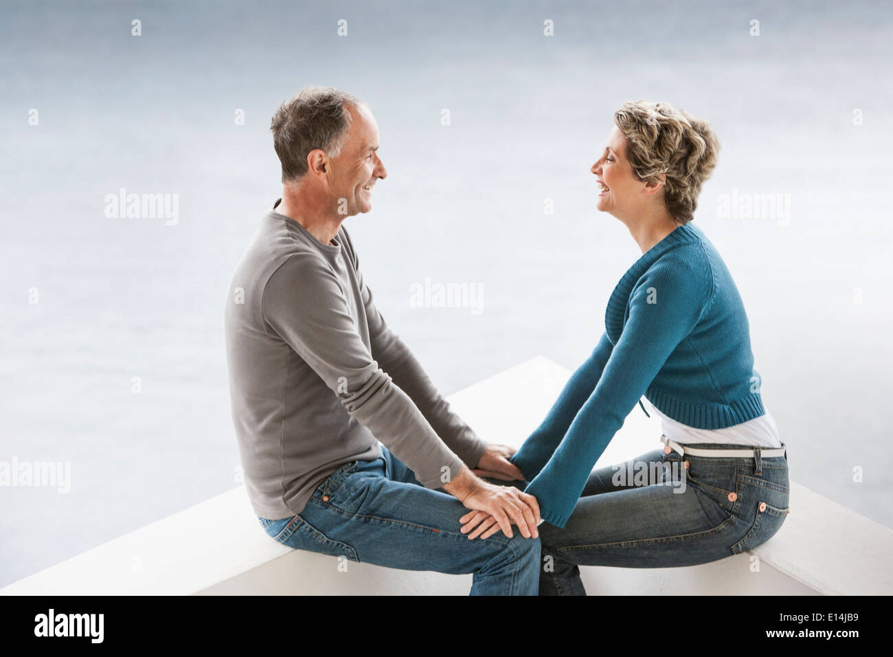 Couple sitting together on benches Stock Photo - Alamy
