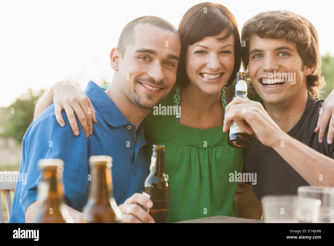 Friends drinking beer together outdoors Stock Photo - Alamy