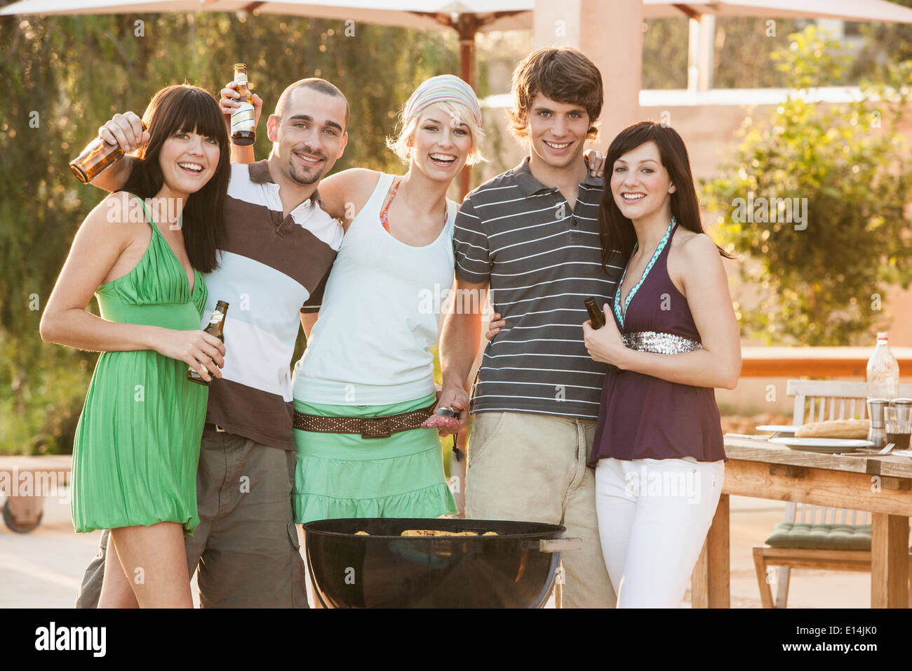 Friends having barbecue outdoors Stock Photo - Alamy