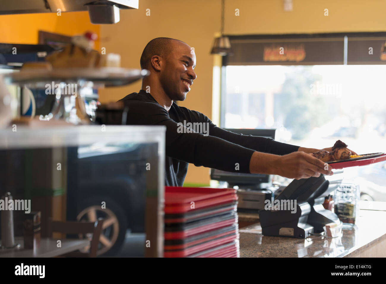 Black server working in cafe Stock Photo - Alamy