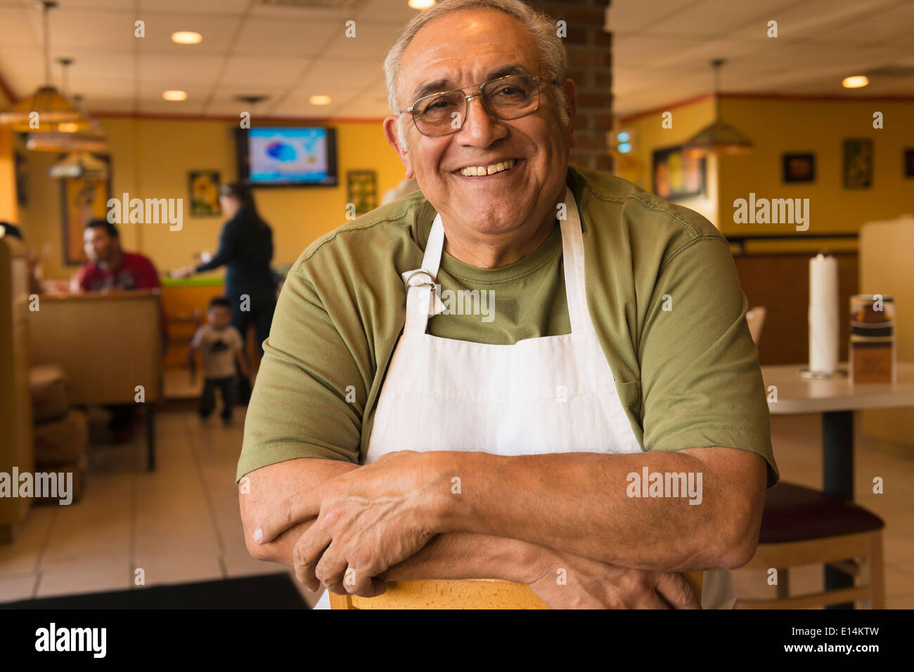 Hispanic server smiling in cafe Stock Photo - Alamy