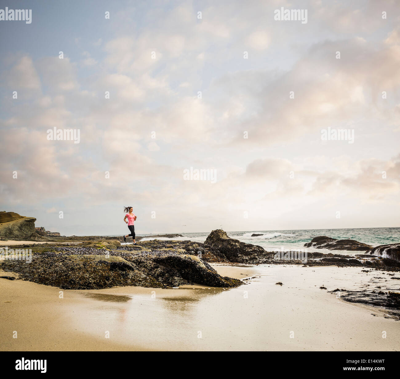 Woman running in beach hi-res stock photography and images - Alamy