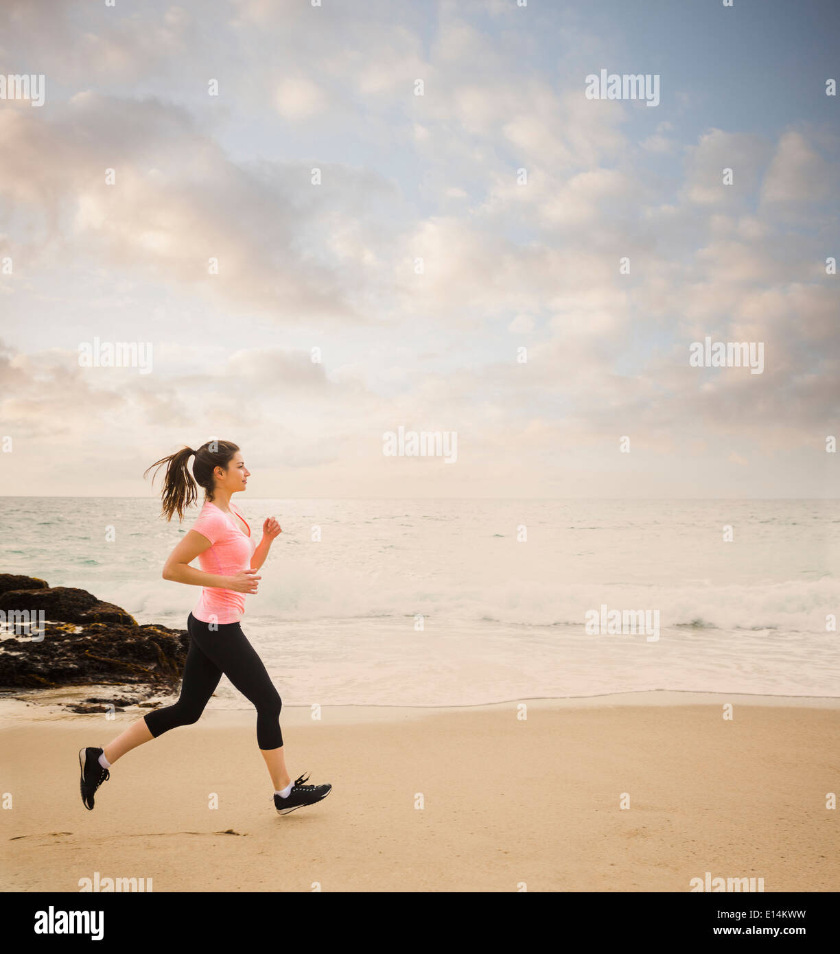 Woman running beach hi-res stock photography and images - Alamy