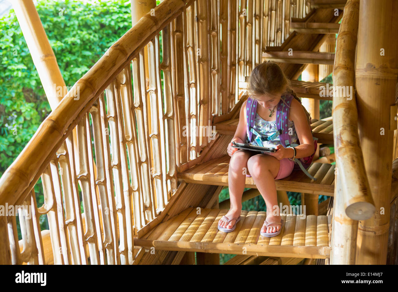 Caucasian girl reading on steps Stock Photo - Alamy