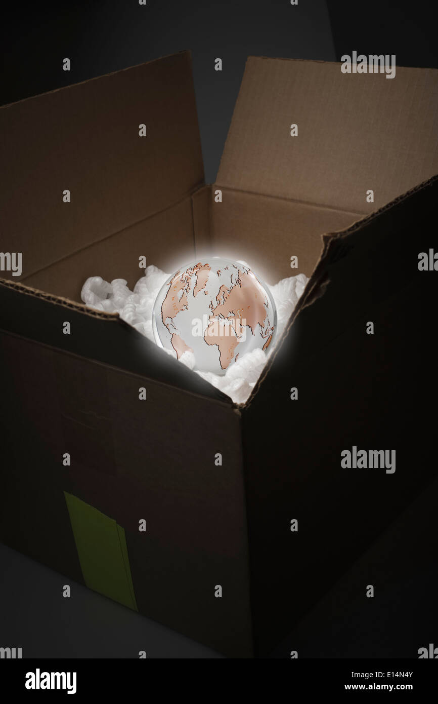 Glowing globe in delivery box Stock Photo - Alamy