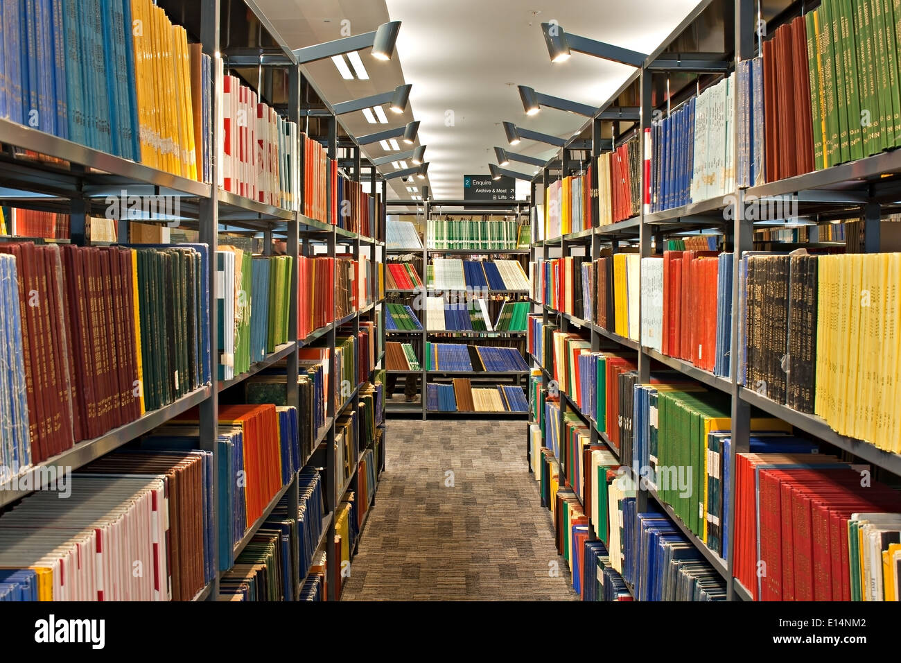 Library books stacked on shelving in modern library Stock Photo - Alamy