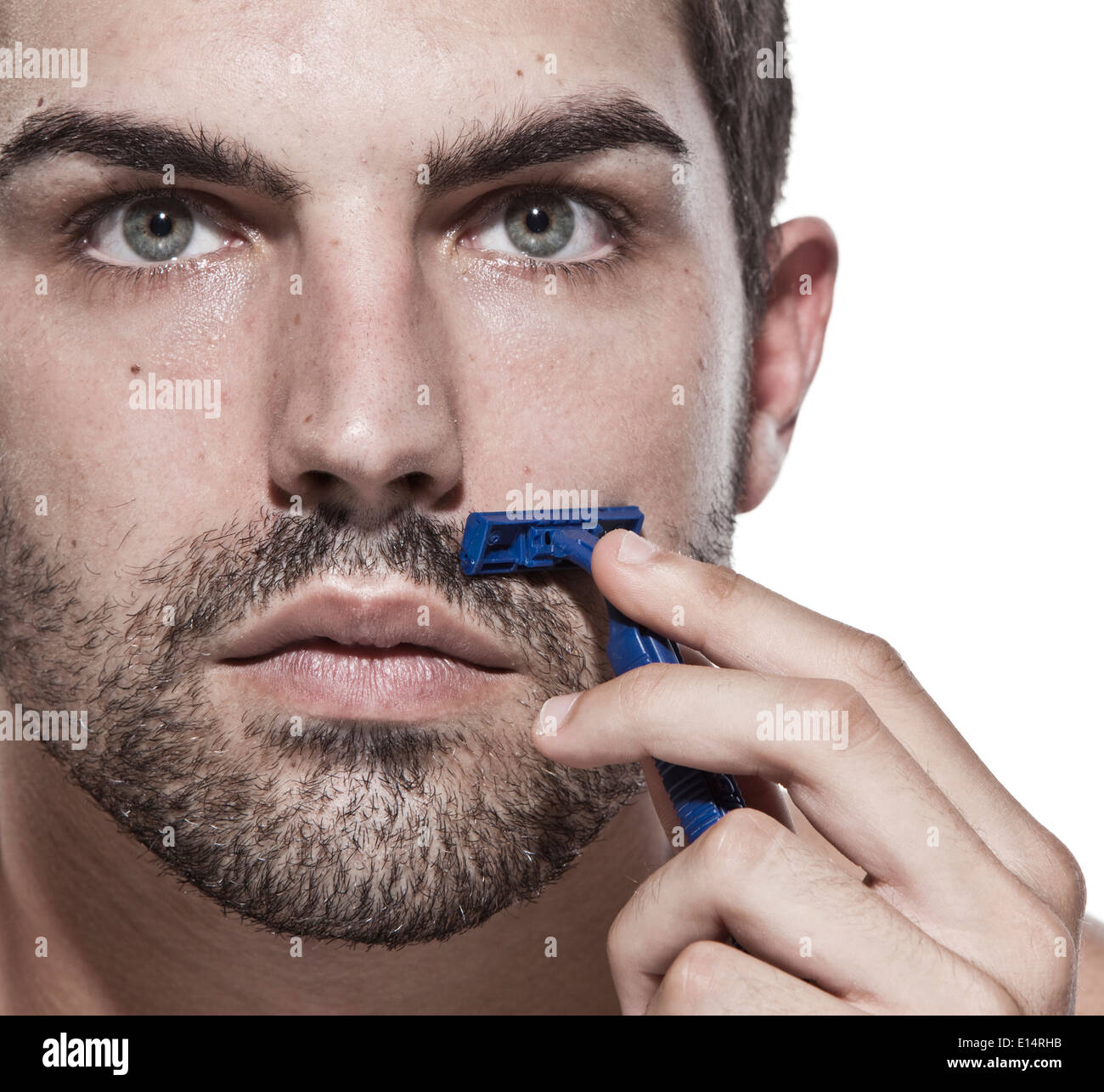 Caucasian man shaving his beard Stock Photo - Alamy