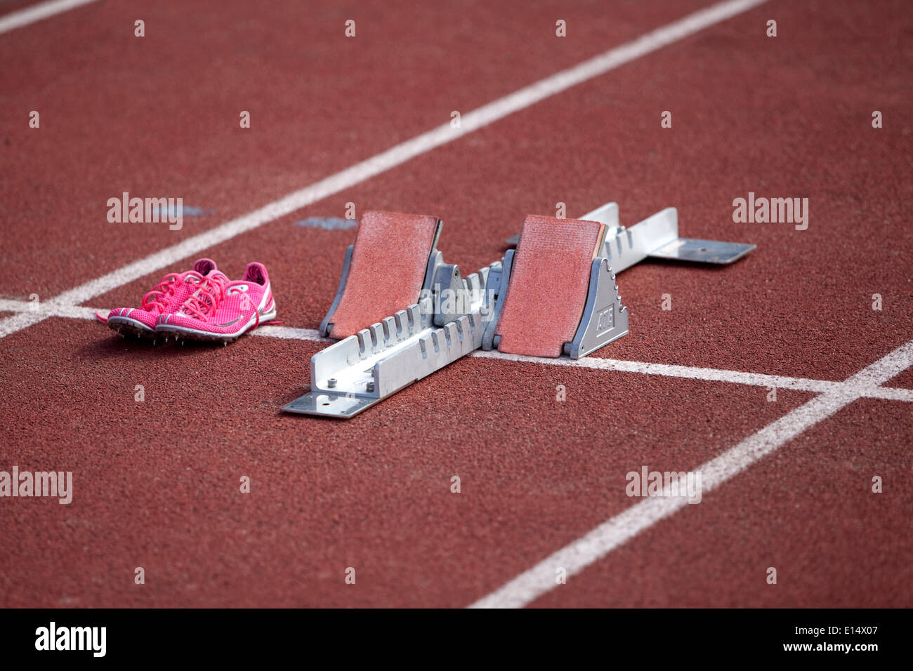 Running shoes, running track, starting block Stock Photo - Alamy