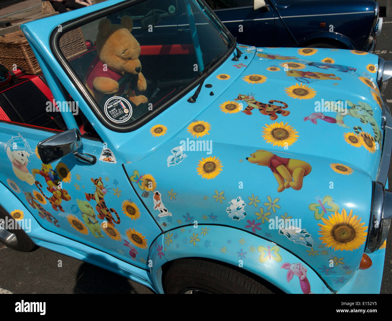 At a car rally a Mini Cooper has a "Winnie the Pooh" paint job Stock ...