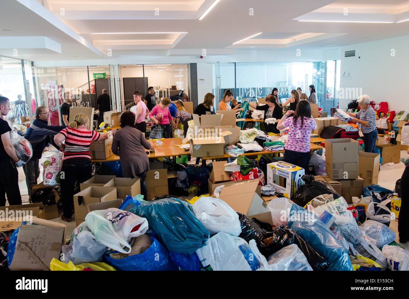 Volunteers sorting and packing clothes for countries affected in severe ...