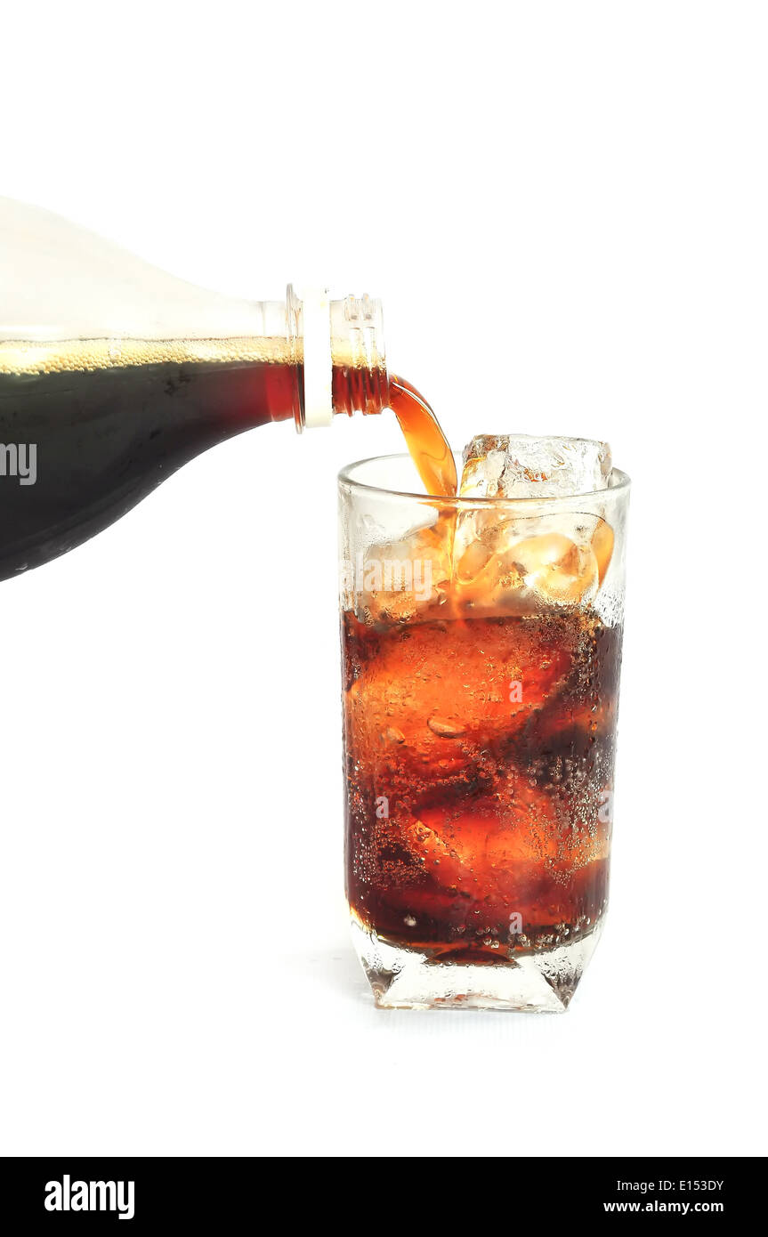 Pouring cola drink from a bottle into glass on white background Stock ...