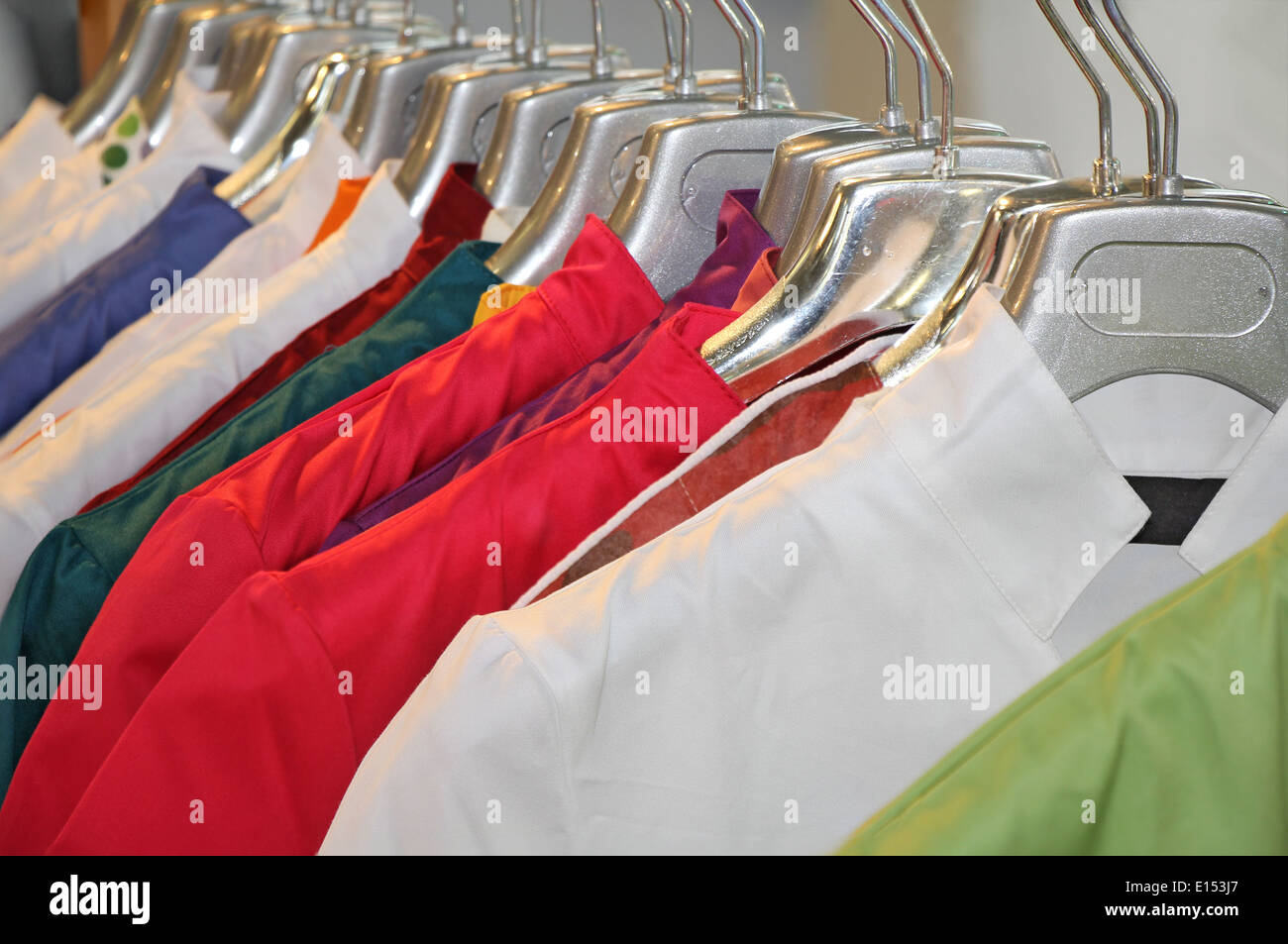 Colorful clothes hanging in wardrobe Stock Photo - Alamy