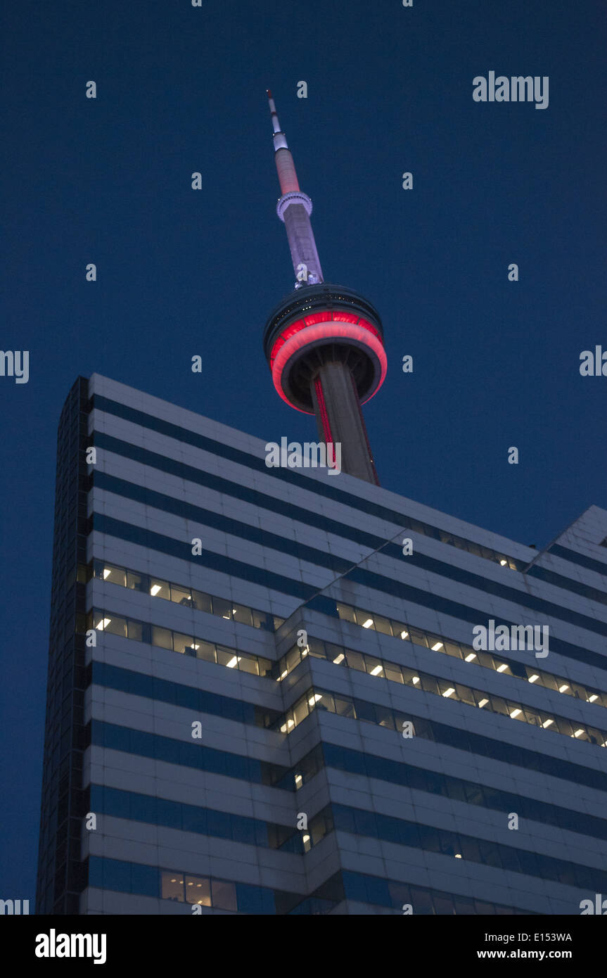 Toronto, lit up CN Tower and office building at night Stock Photo - Alamy