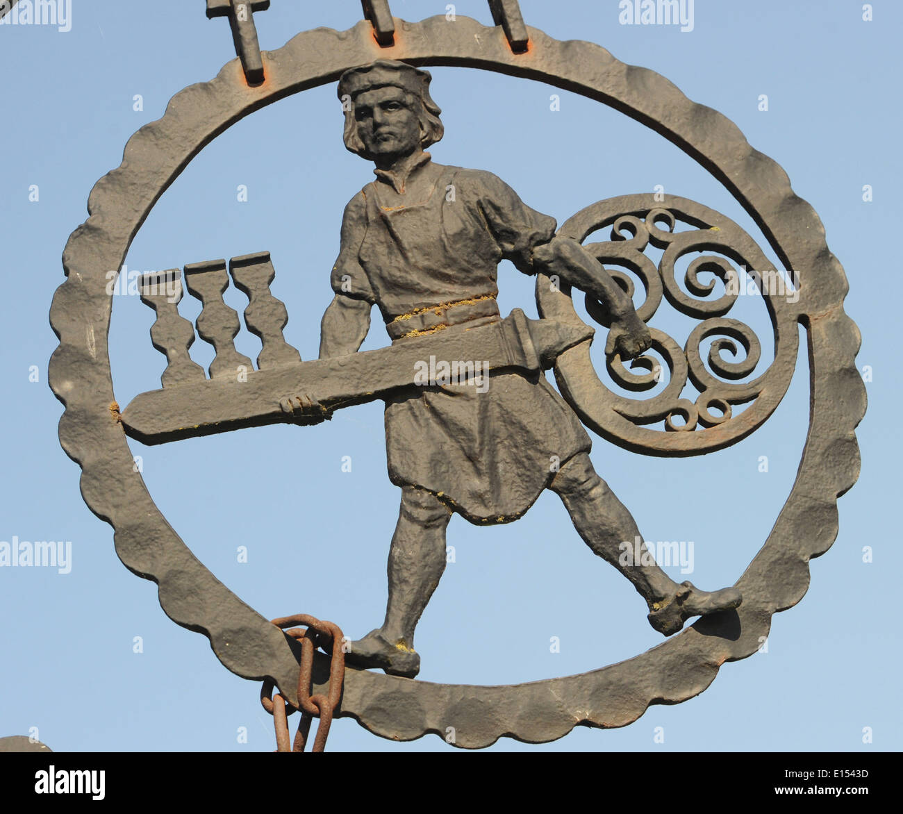 Greifswald, Germany. 20th May, 2014. A wrought iron guild sign, a man ...