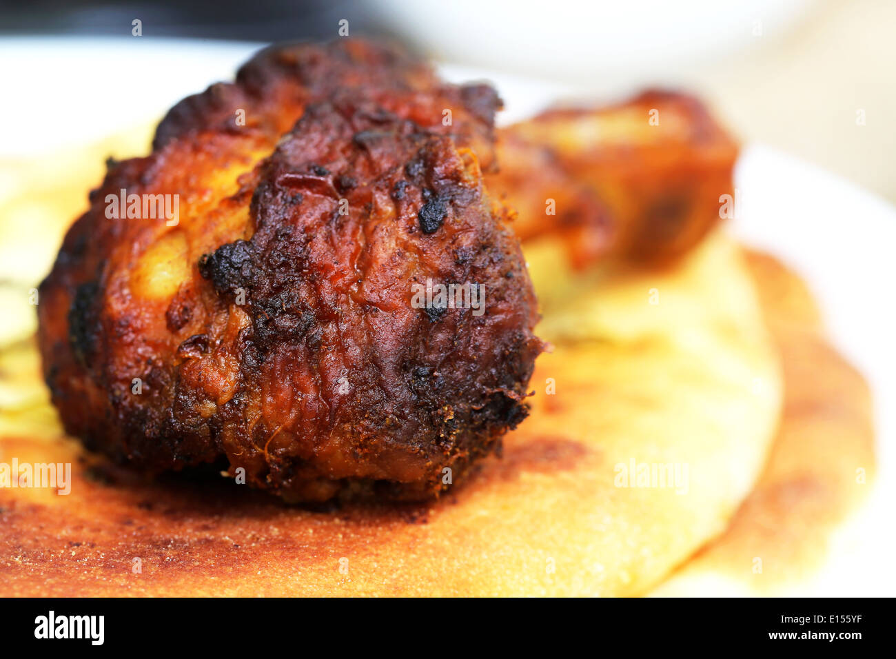 Garlic nan with grilled chiken on serving plate Stock Photo - Alamy