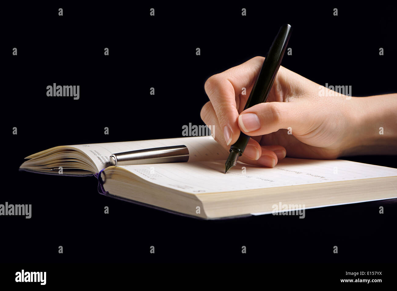 Womans hand writing in notebook hi-res stock photography and images - Alamy