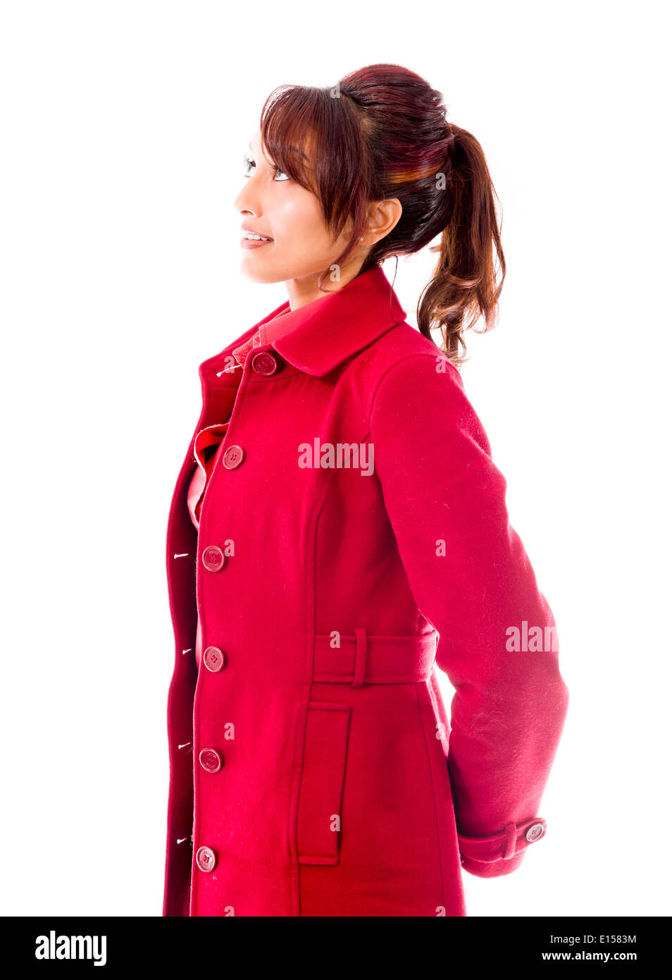 Side profile of an Indian young woman looking up with hands behind her ...