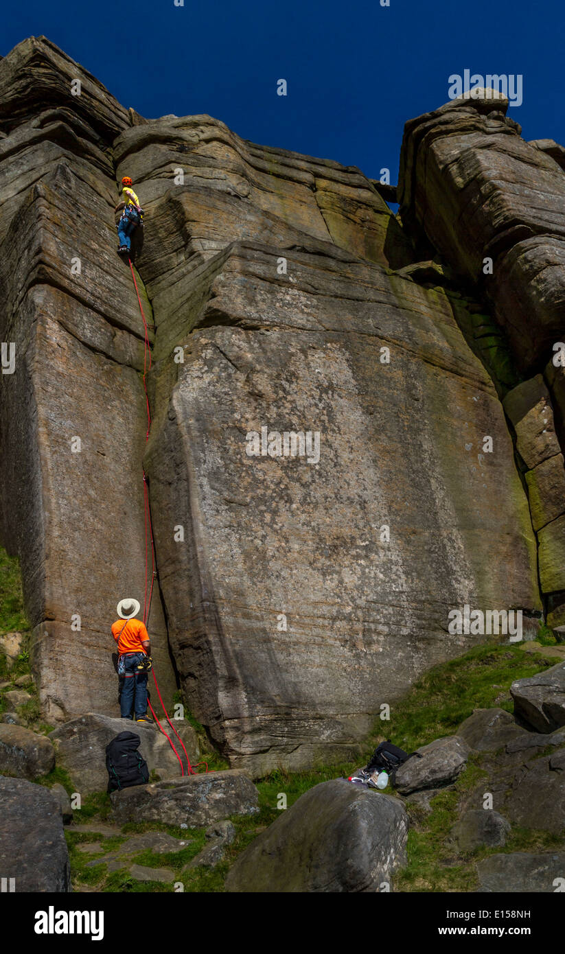 Rock climber nearing the top of Goliath's Groove, Stanage Edge ...