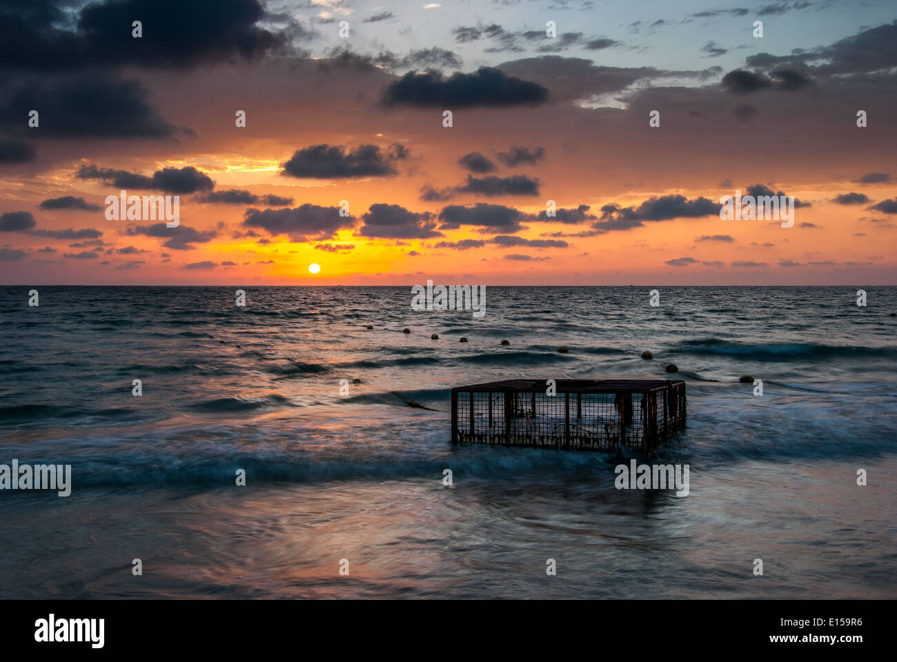Tropical Beach with Empty Cage in the Sea at Colorful Sunset Stock ...