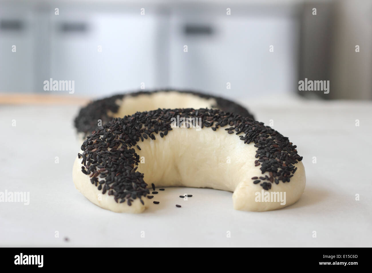 Fresh Bun with black sesame seeds on paper Stock Photo - Alamy