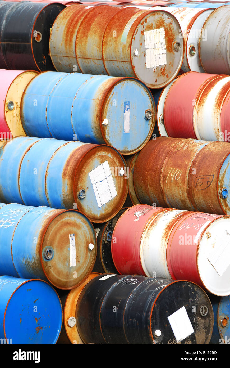 Used 55 gallon chemical drums in a storage yard awaiting recycling ...