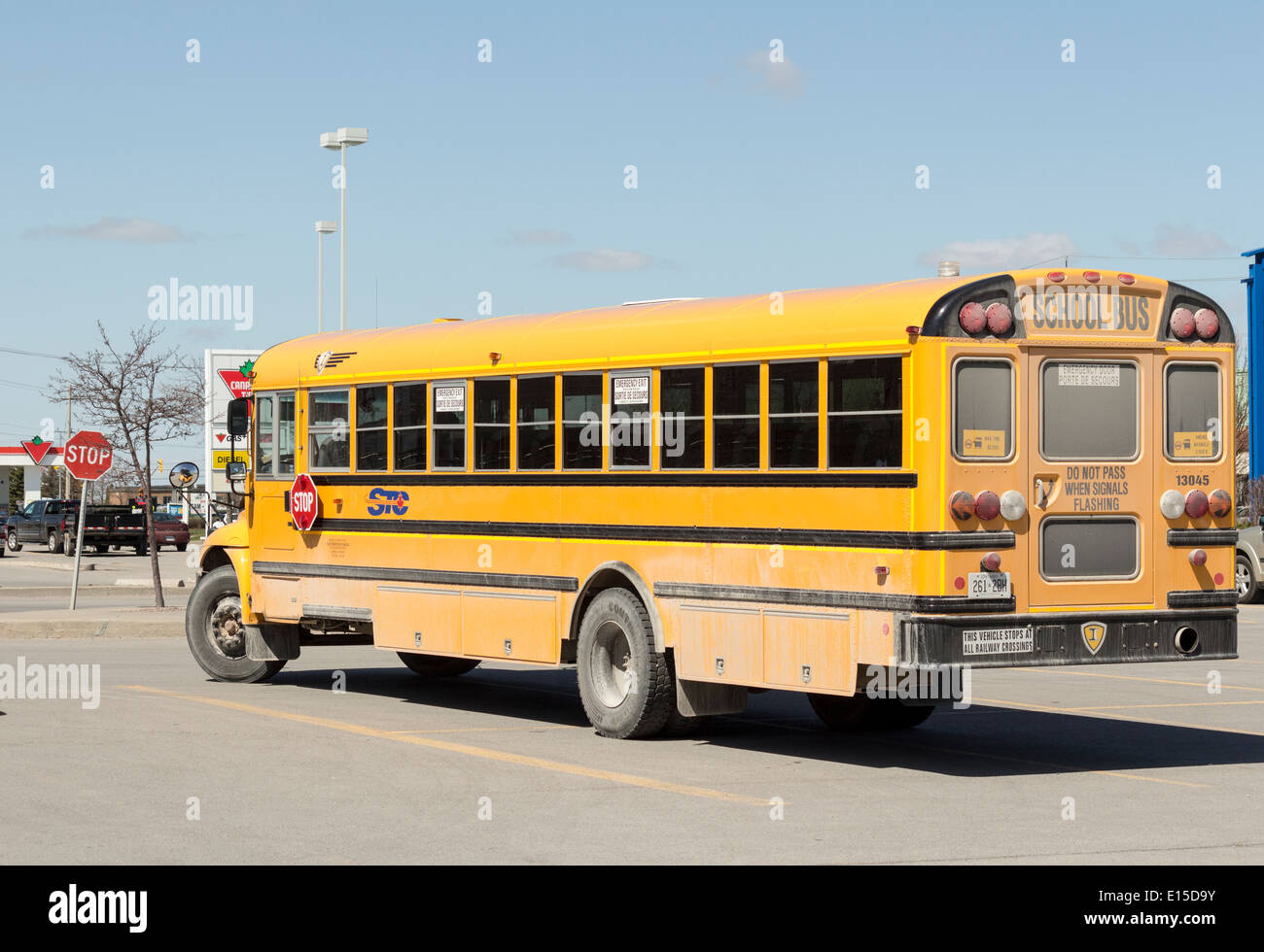 Yellow school bus parked in a mall parking lot Stock Photo - Alamy