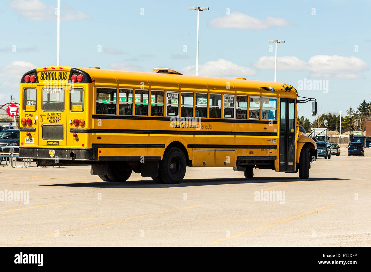 Yellow school bus parked in a mall parking lot Stock Photo - Alamy