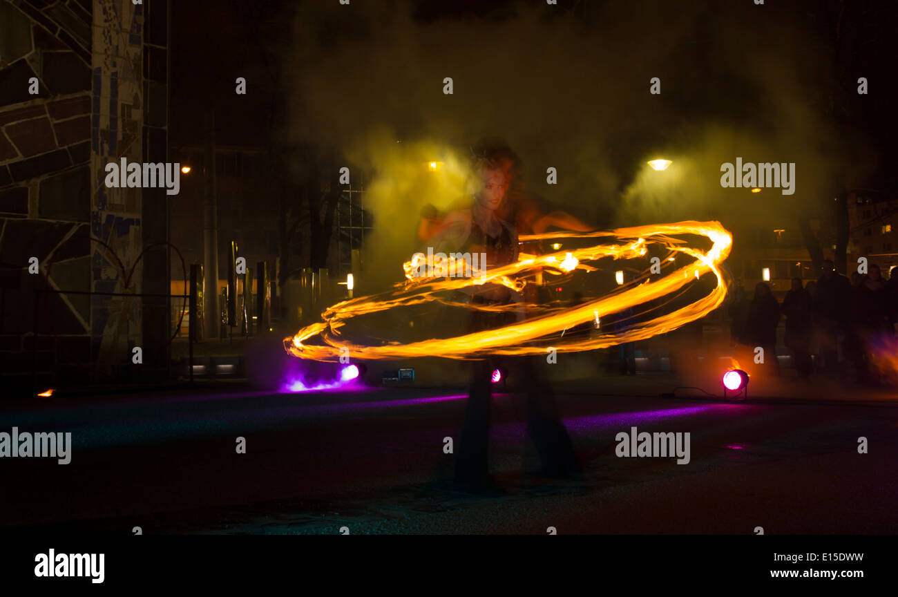 Woman showing fire show at night Stock Photo - Alamy