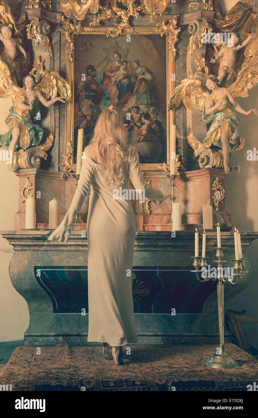 Young woman standing in front of altar, back view Stock Photo - Alamy
