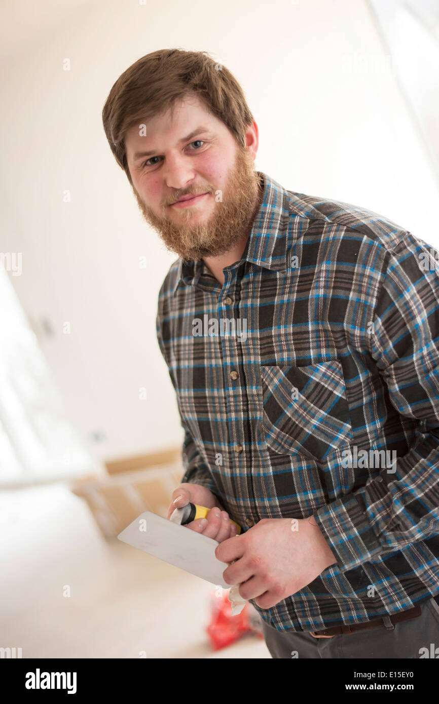 Portrait of man with brick trowel Stock Photo - Alamy