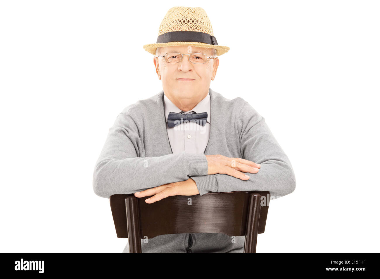Senior gentleman with hat sitting on a chair Stock Photo - Alamy
