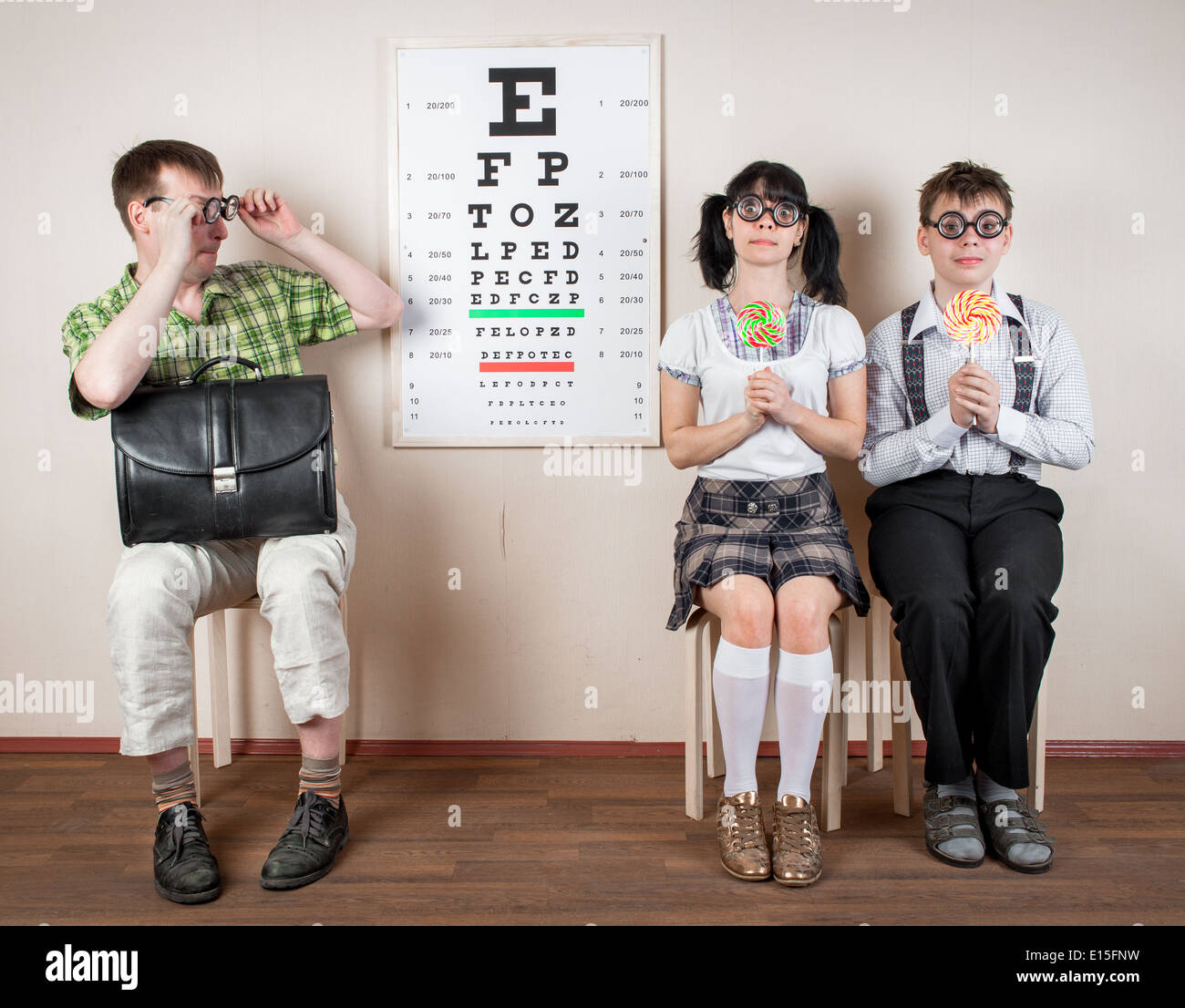 Three funny person wearing spectacles in an office at the doctor Stock ...