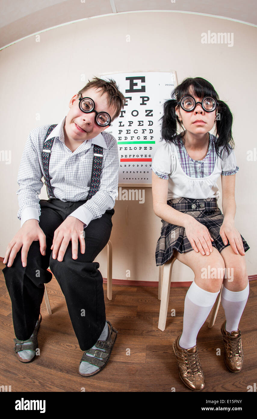 Two funny person wearing spectacles in an office at the doctor Stock ...