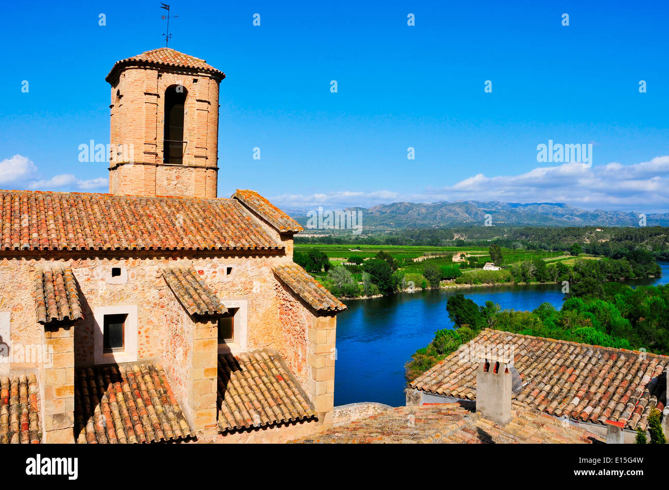 Esglesia Vella Church and Ebro River in Miravet, Spain with the Serra ...