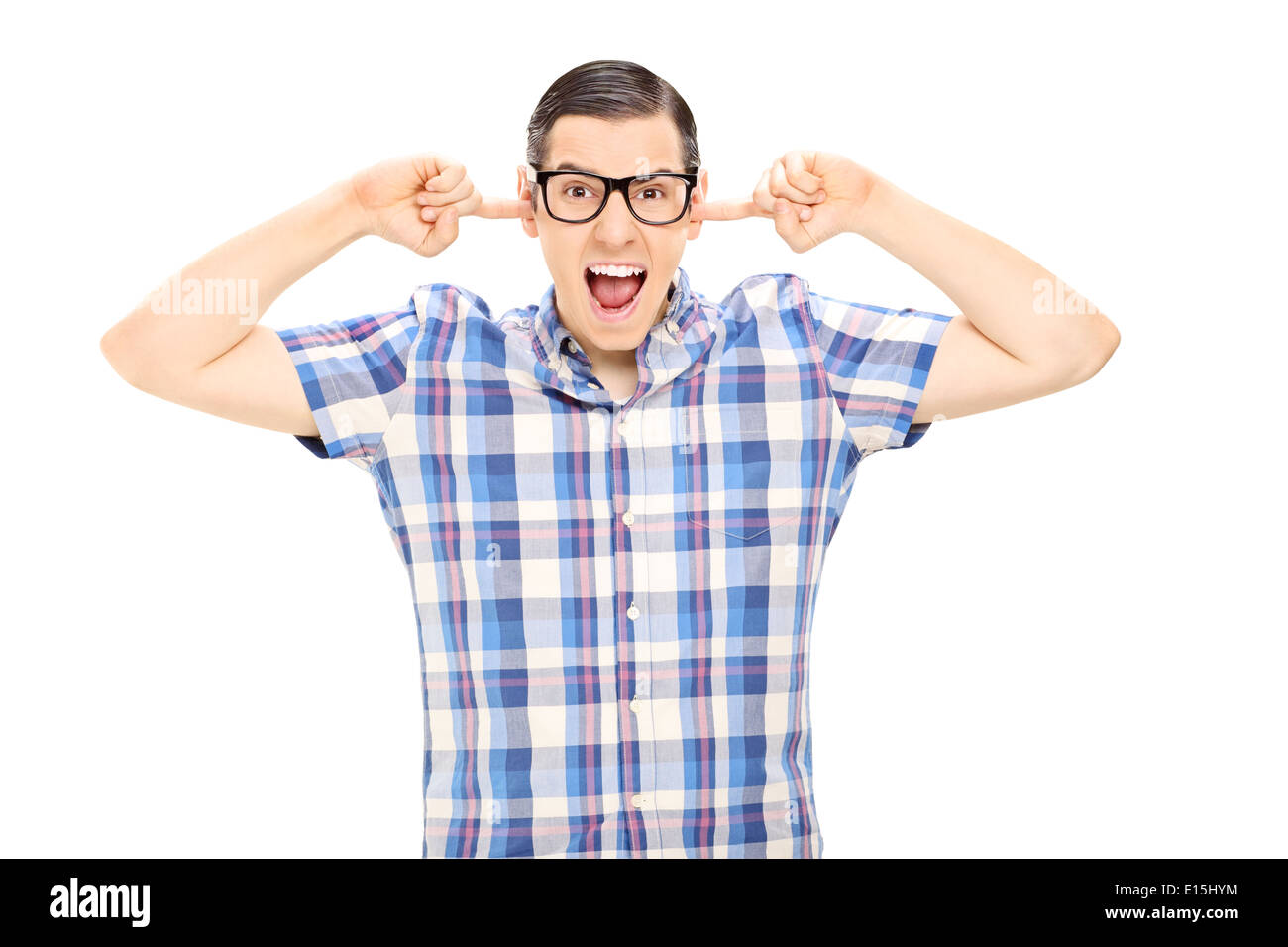 Nervous man plugging his ears Stock Photo - Alamy