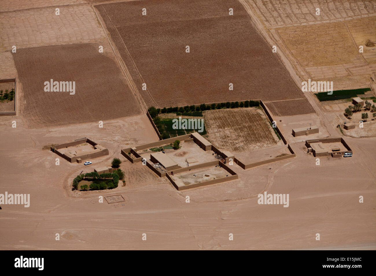 Aerial view of a walled compound and farm in the desert town of Girishk ...