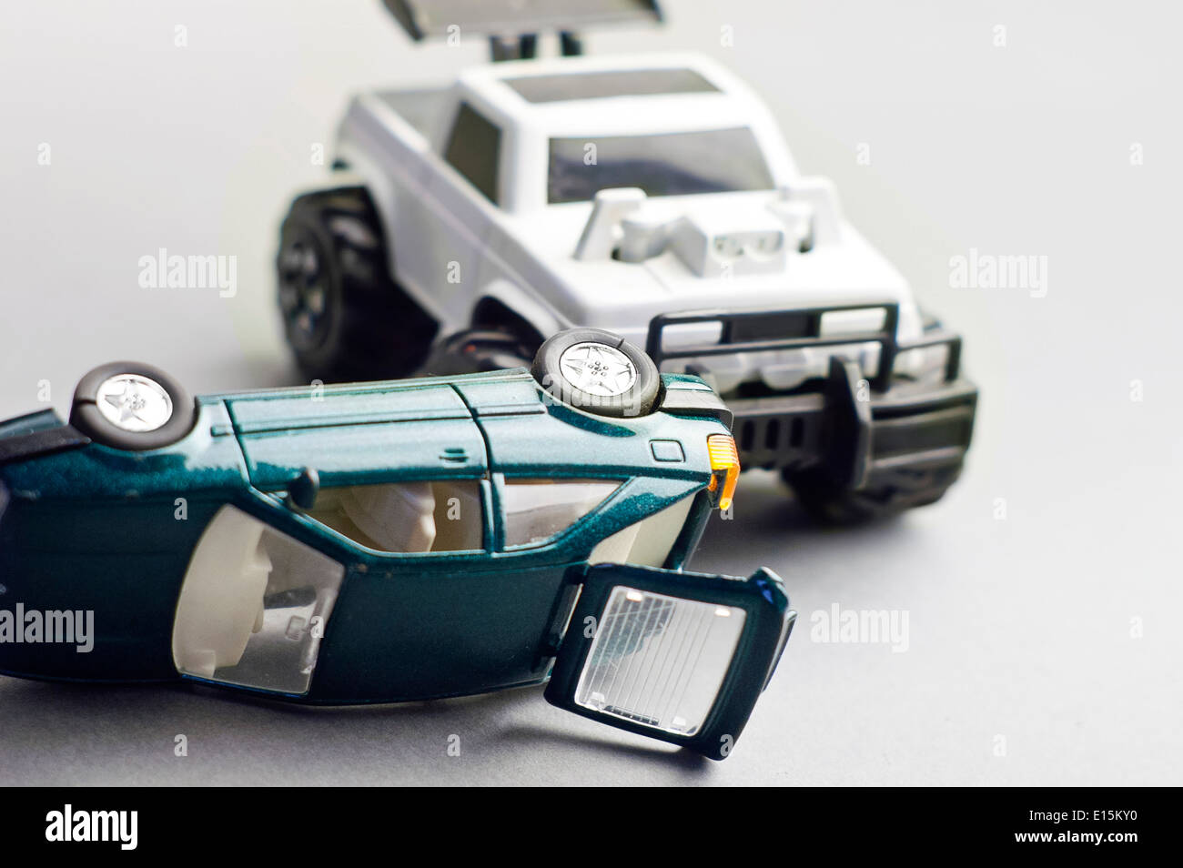 toy cars crashed, one is tipped over, concept of a danger on a road ...