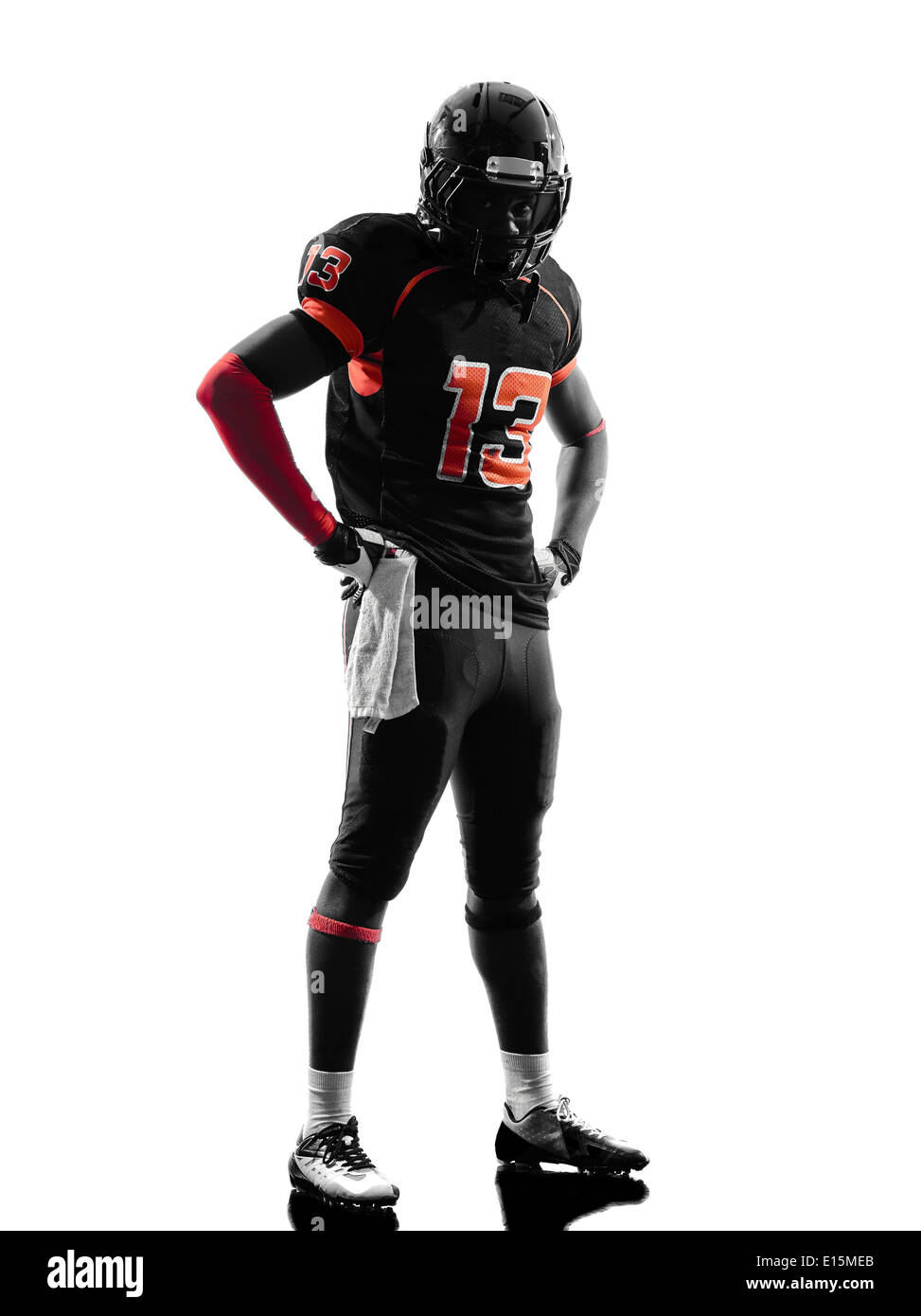 one american football player standing in silhouette shadow on white ...