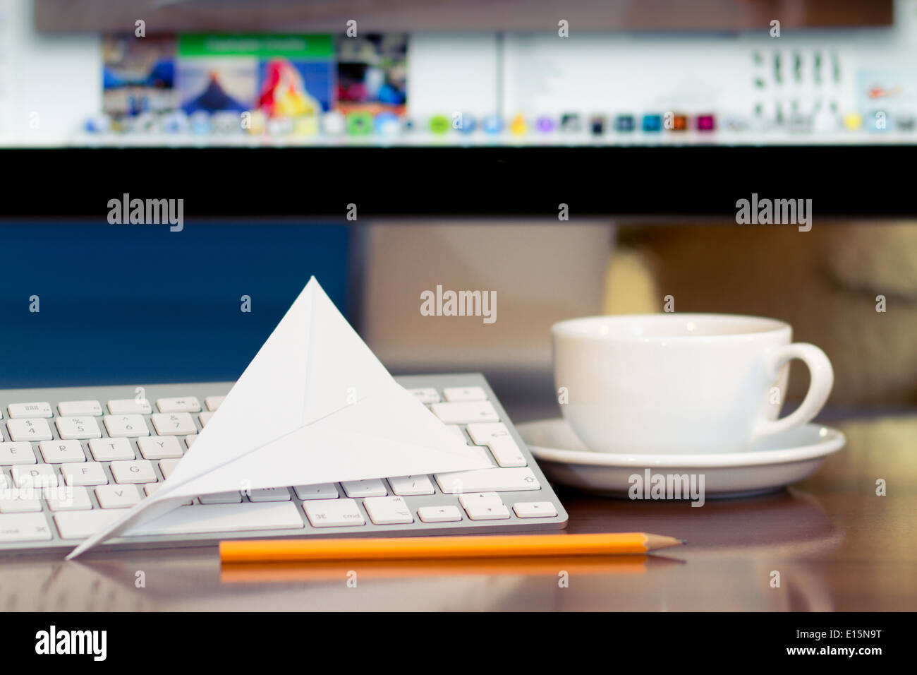 Paper airplane on the keyboard. PC display at background Stock Photo ...