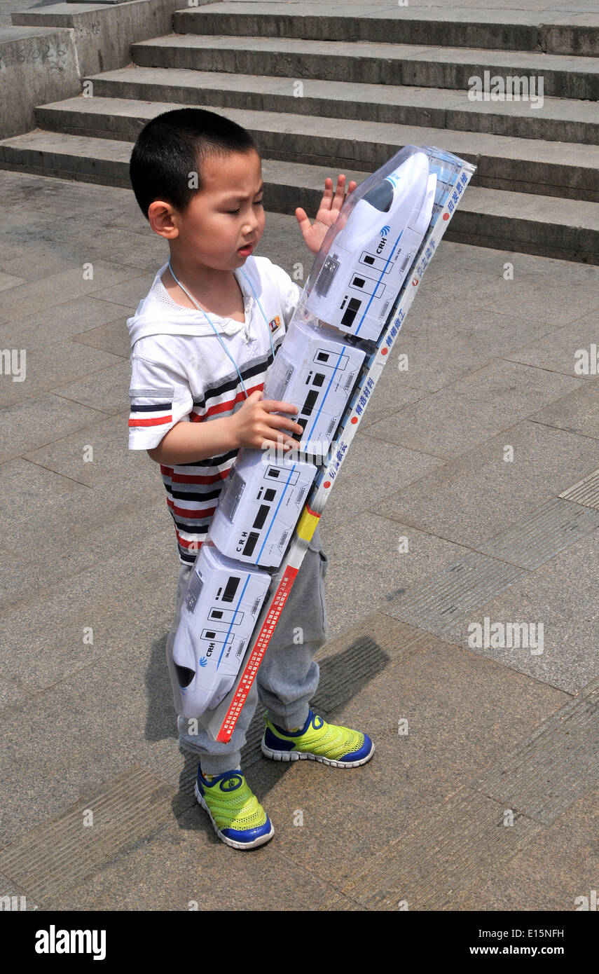chinese child with a train toy in street, Xi'an, China Stock Photo - Alamy